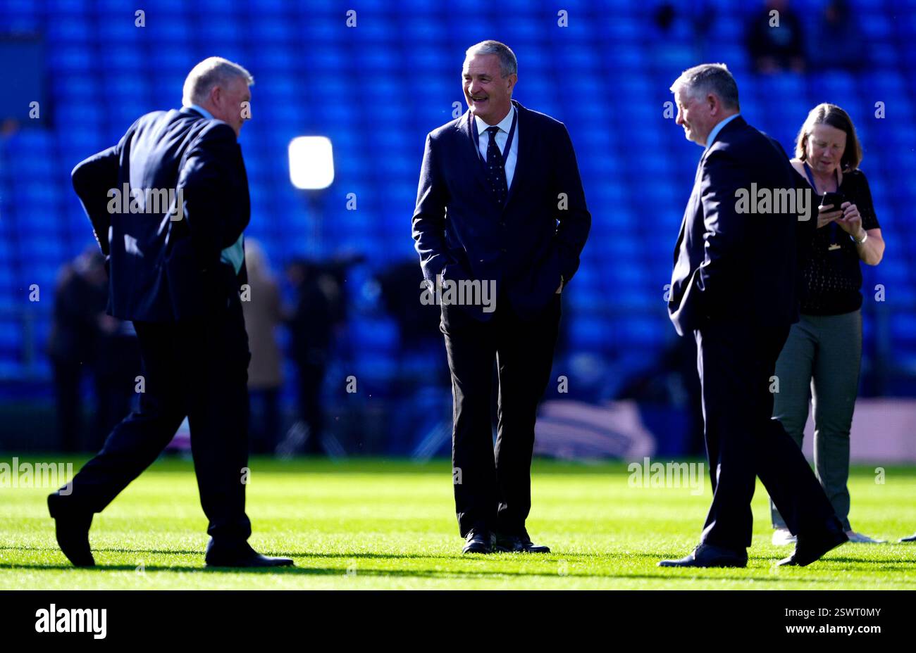 Former Everton player Derek Mountfield (centre) on the pitch ahead of ...