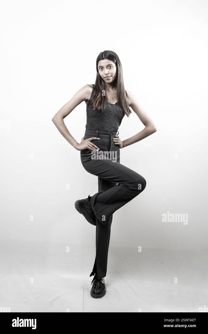 a tall slim caucasian female model with black hair wearing a black suit ...