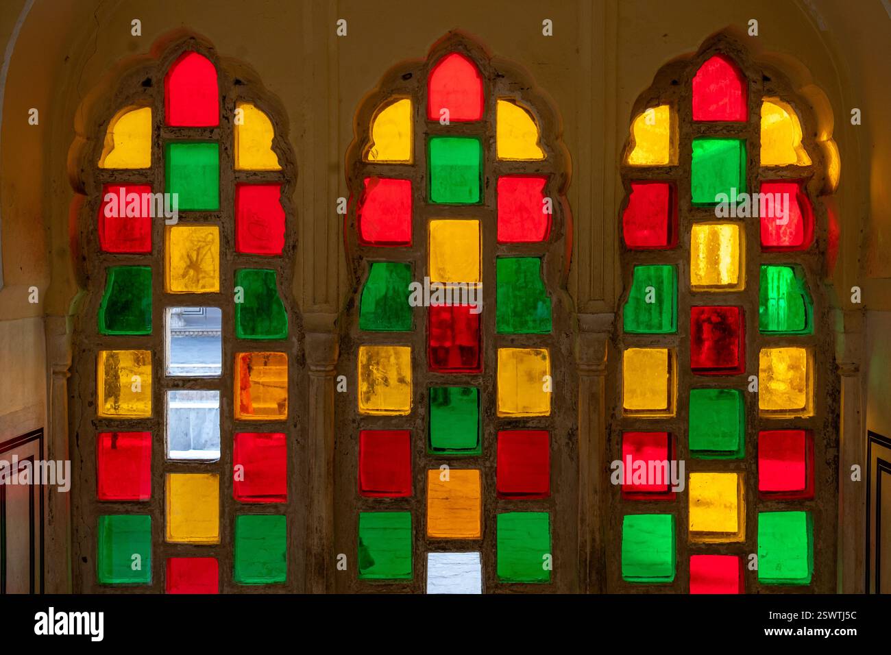 India. Rajasthan. Jaipur. Hawa Mahal. (Palace of the Winds). Multicolored stained glass windows ...