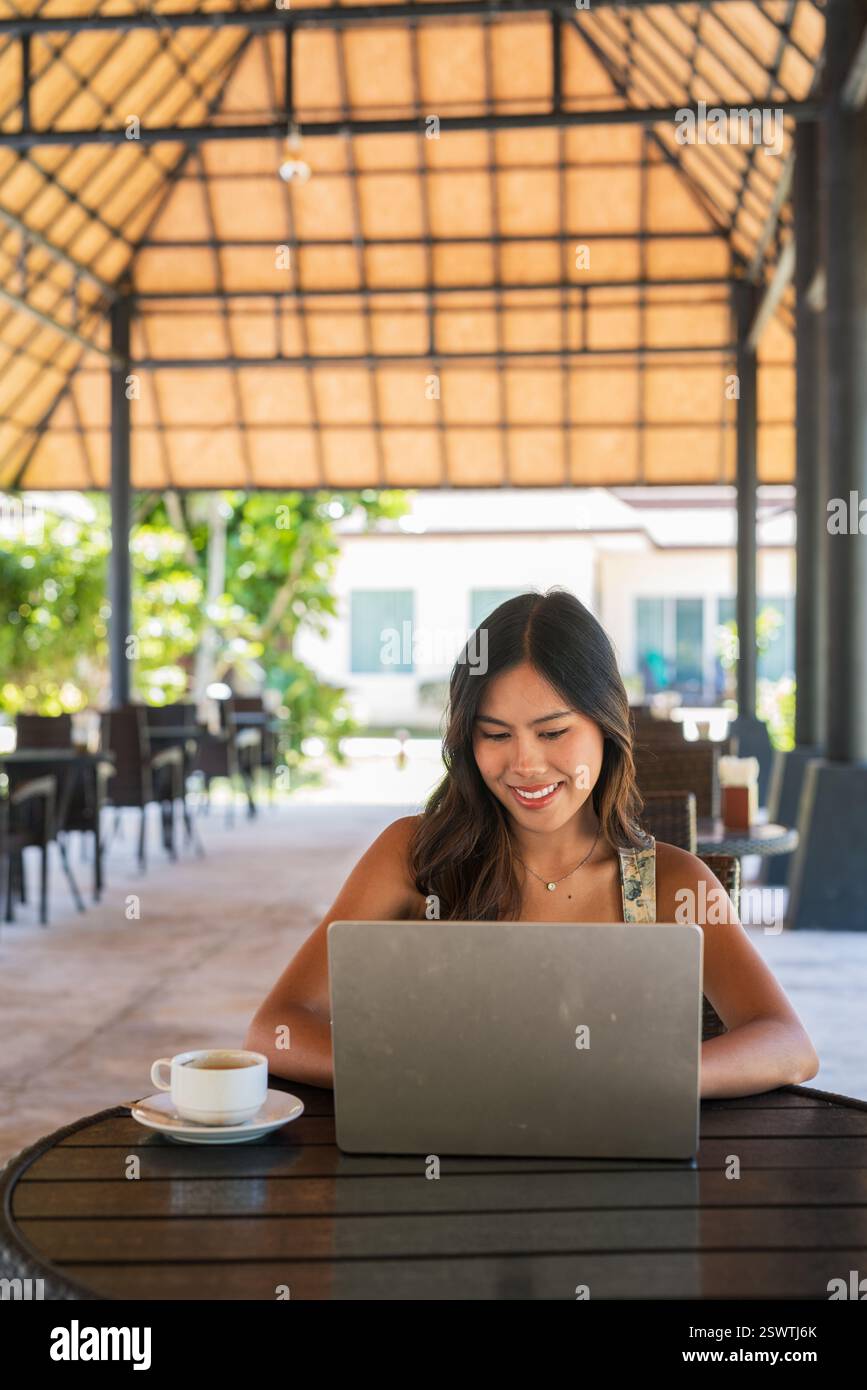 Smiling woman sitting laptop hi-res stock photography and images - Alamy