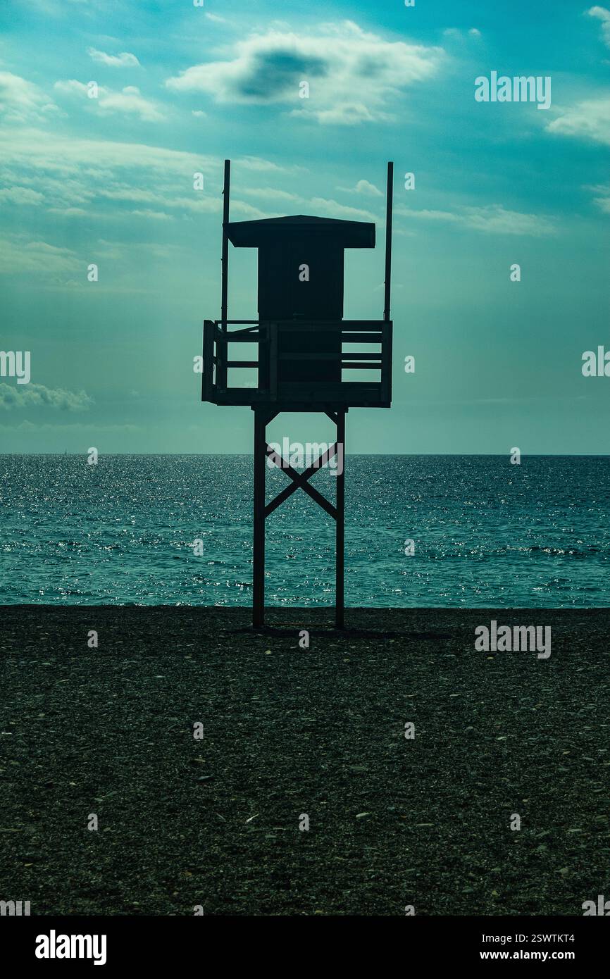 Dramatic blue shot of lifeguards timber look out on stilts looking out ...