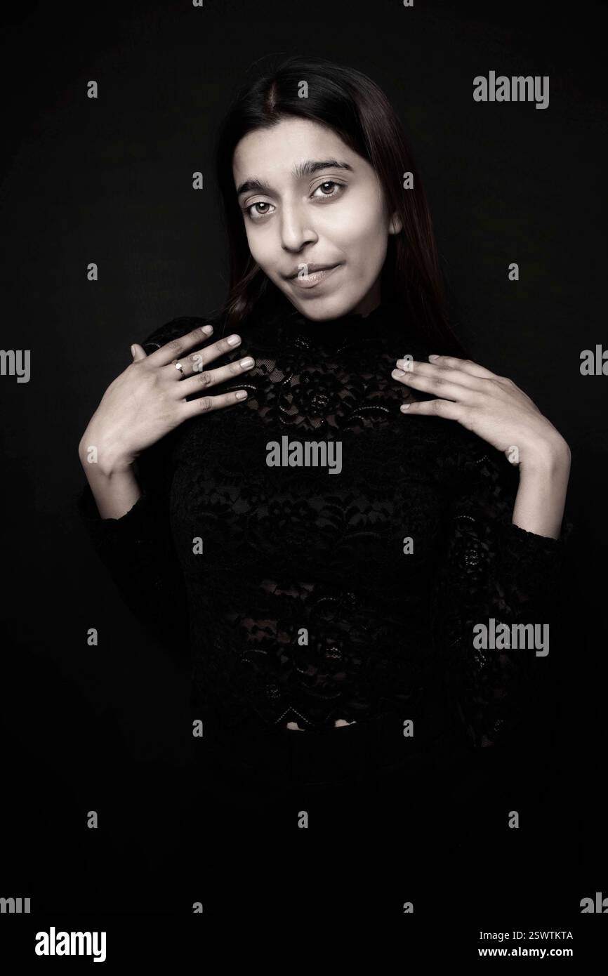 a tall slim caucasian female model with black hair wearing a black suit ...