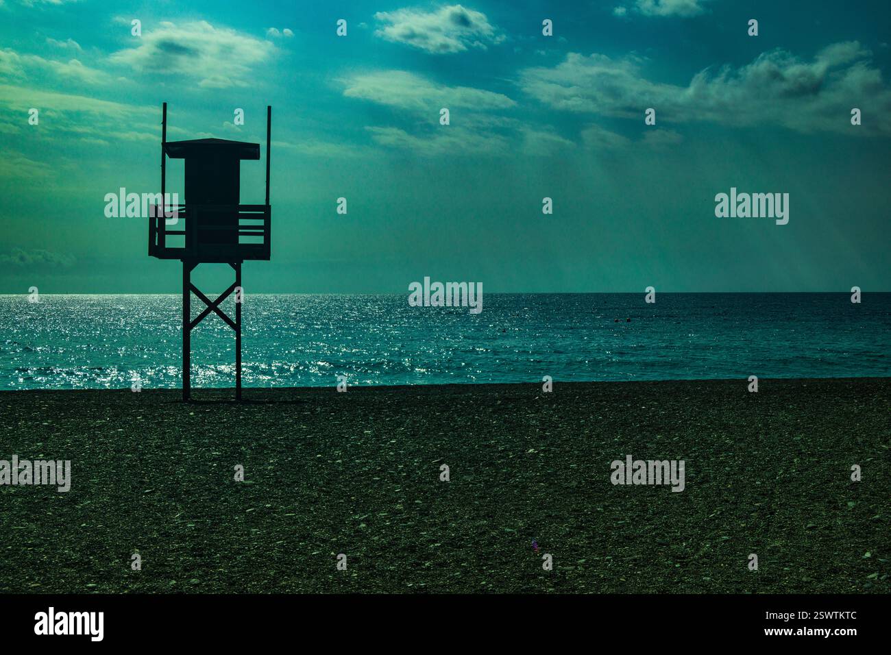 Dramatic blue shot of lifeguards timber look out on stilts looking out ...