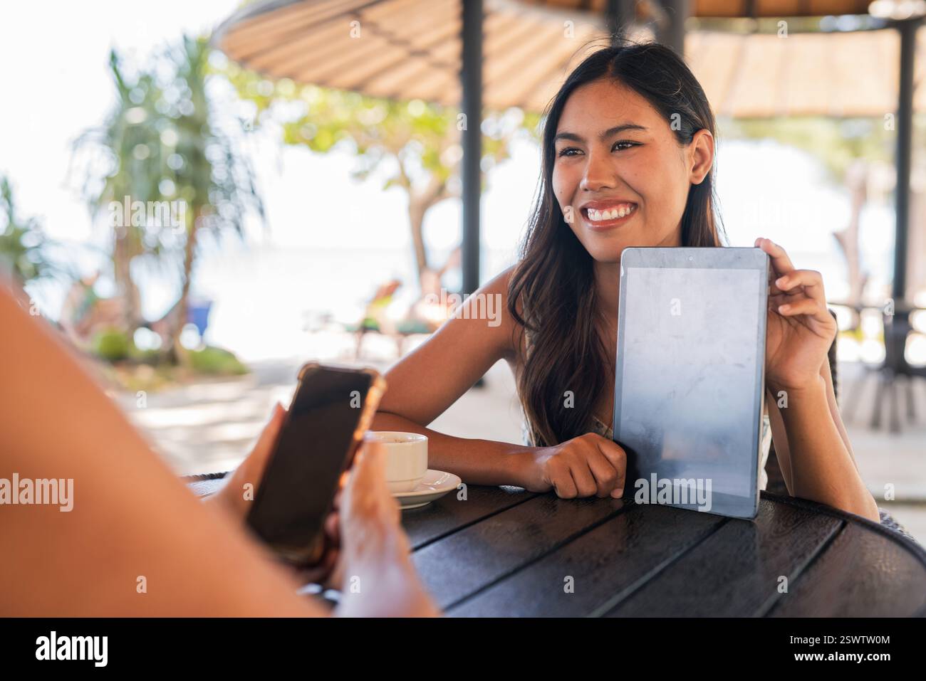 Young woman sitting in city hi-res stock photography and images - Alamy