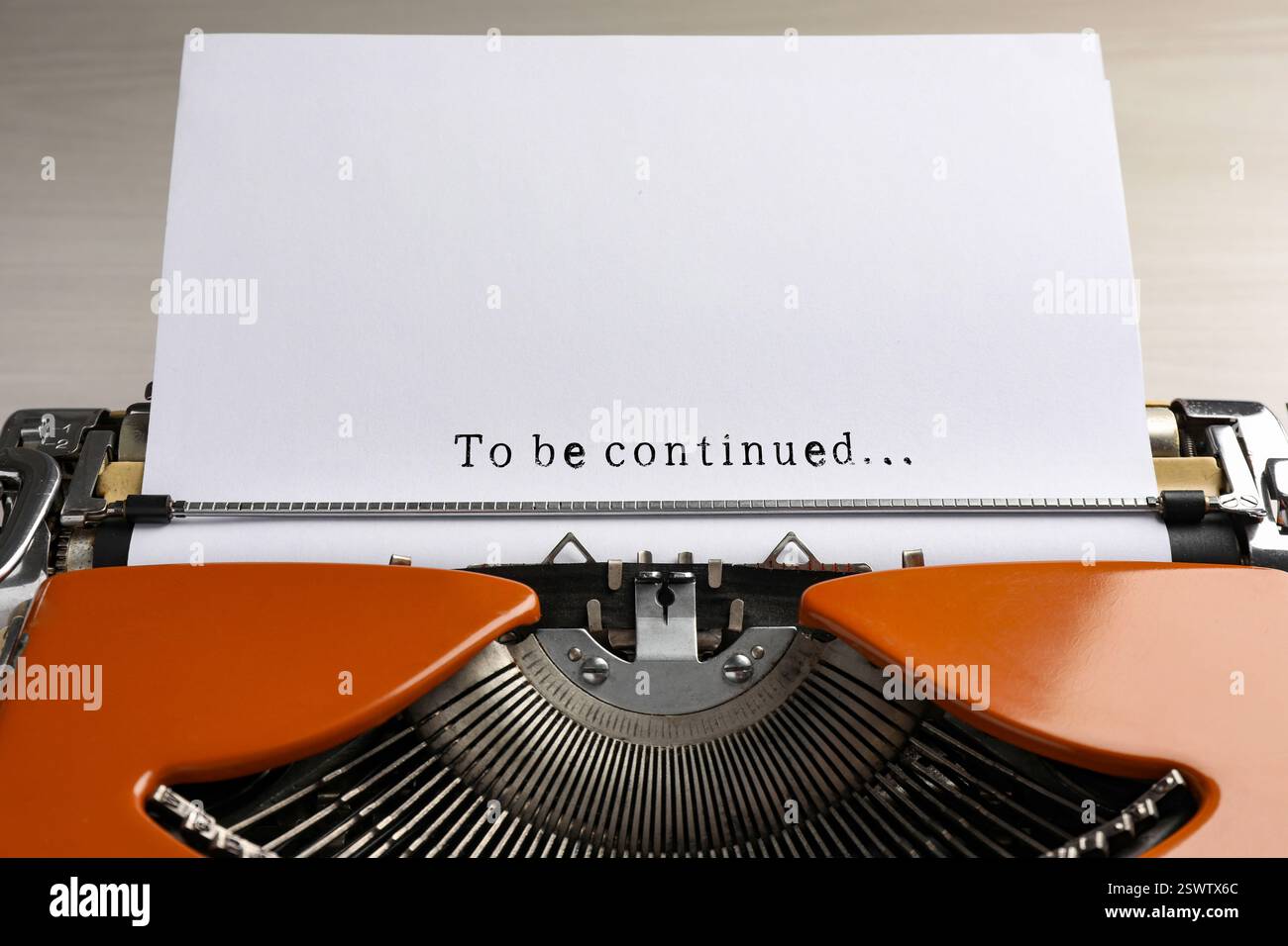 Typewriter with sheet of paper, closeup. Typed text To Be Continued ...