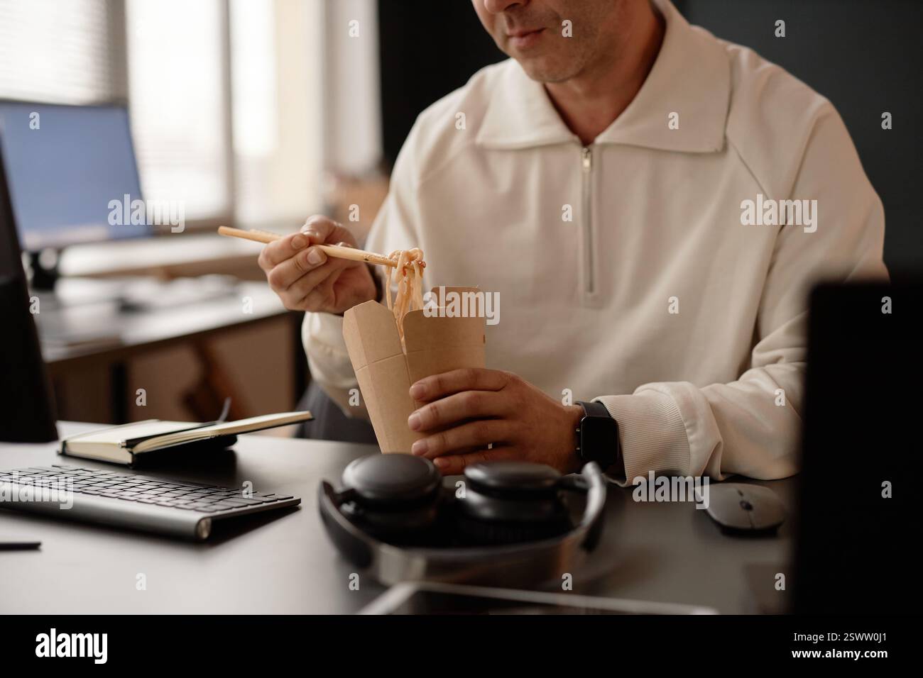 Office worker eating eat with chopstick hi-res stock photography and ...