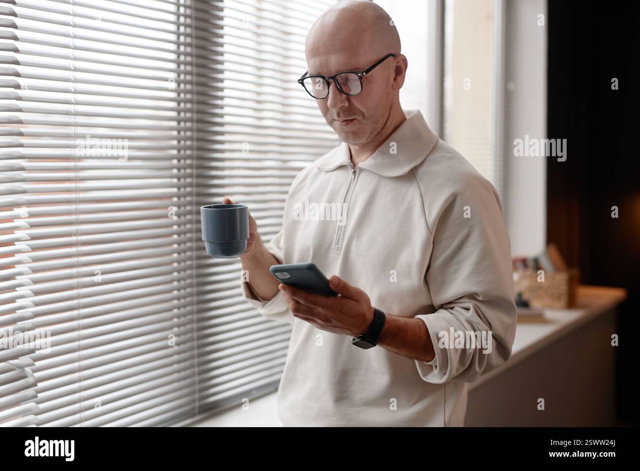 Waist up shot of middle aged man with buzz cut answering message on ...