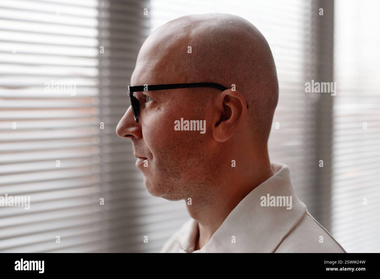 Side view portrait of confident middle aged man with shaved head ...