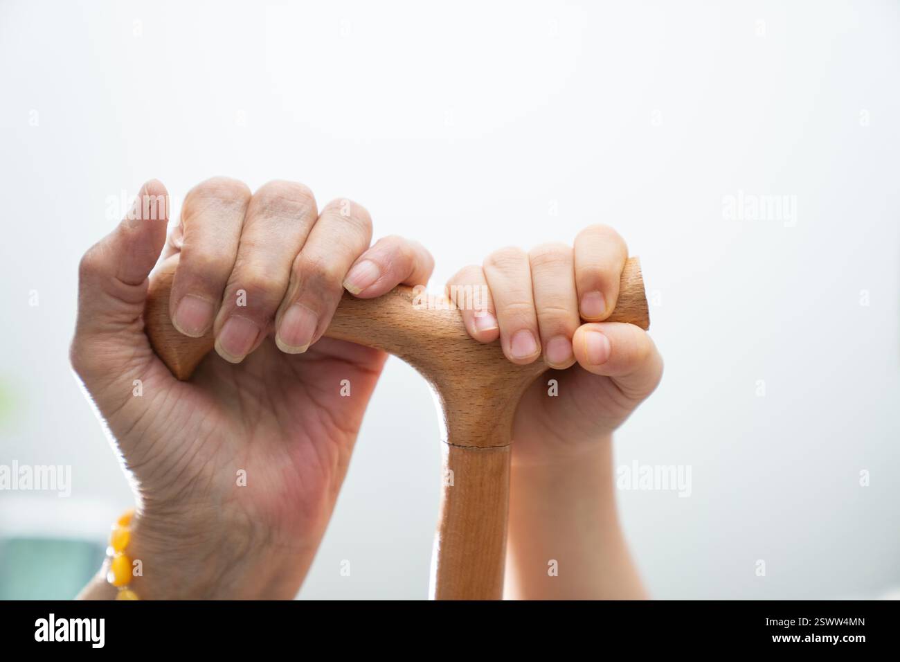 old and child hands holding walking stick Stock Photo - Alamy