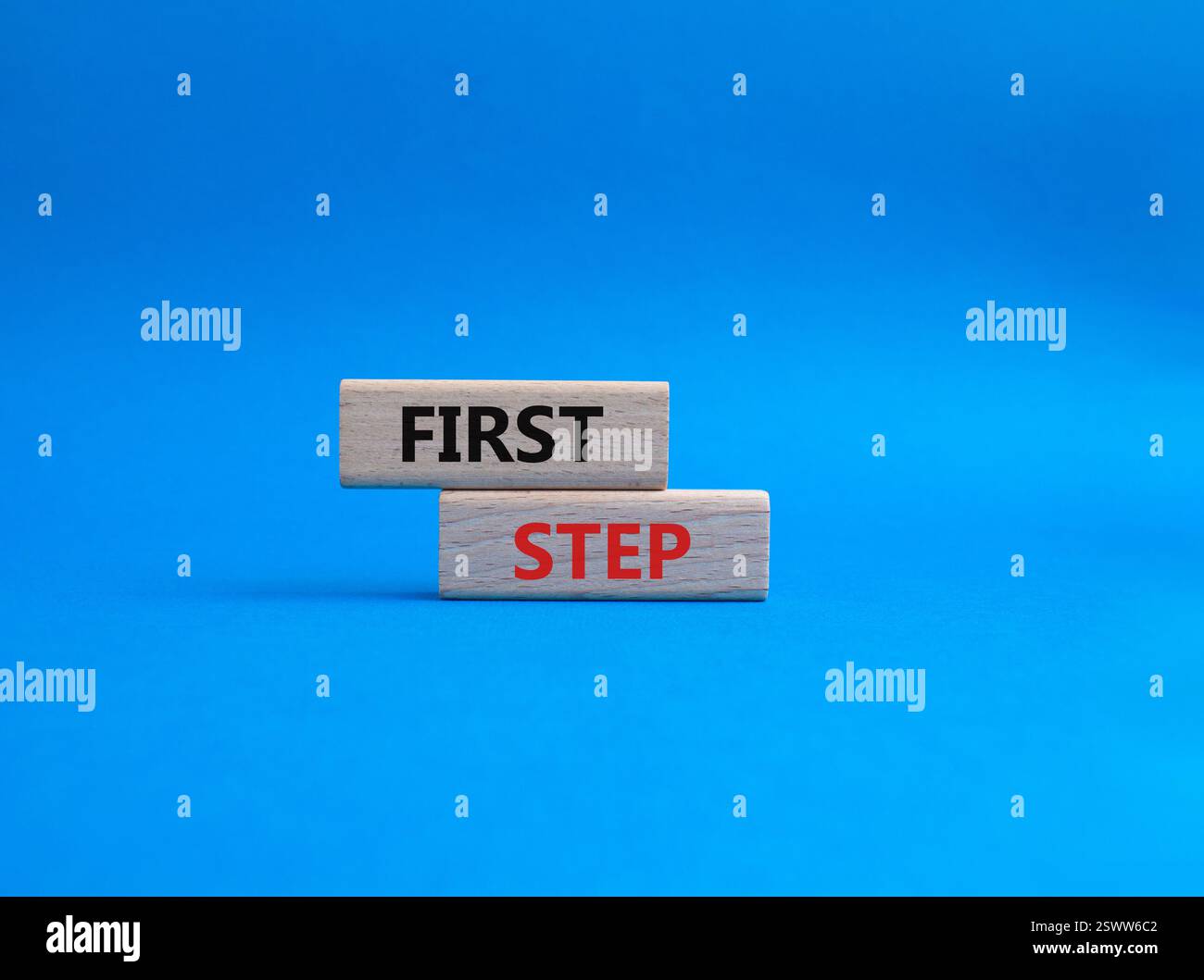 First step symbol. Wooden blocks with words First step. Beautiful blue ...