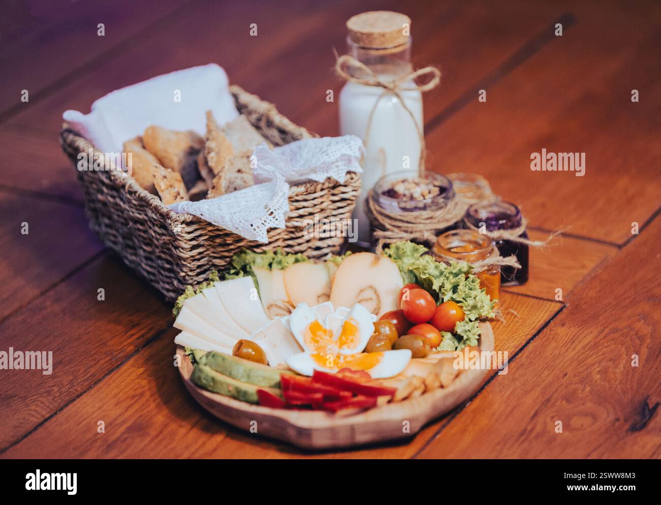 Assorted breakfast foods including bread, milk, vegetables, eggs, and ...