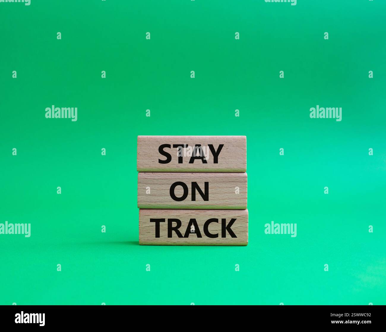 Stay on track symbol. Wooden blocks with words 'Stay on track ...