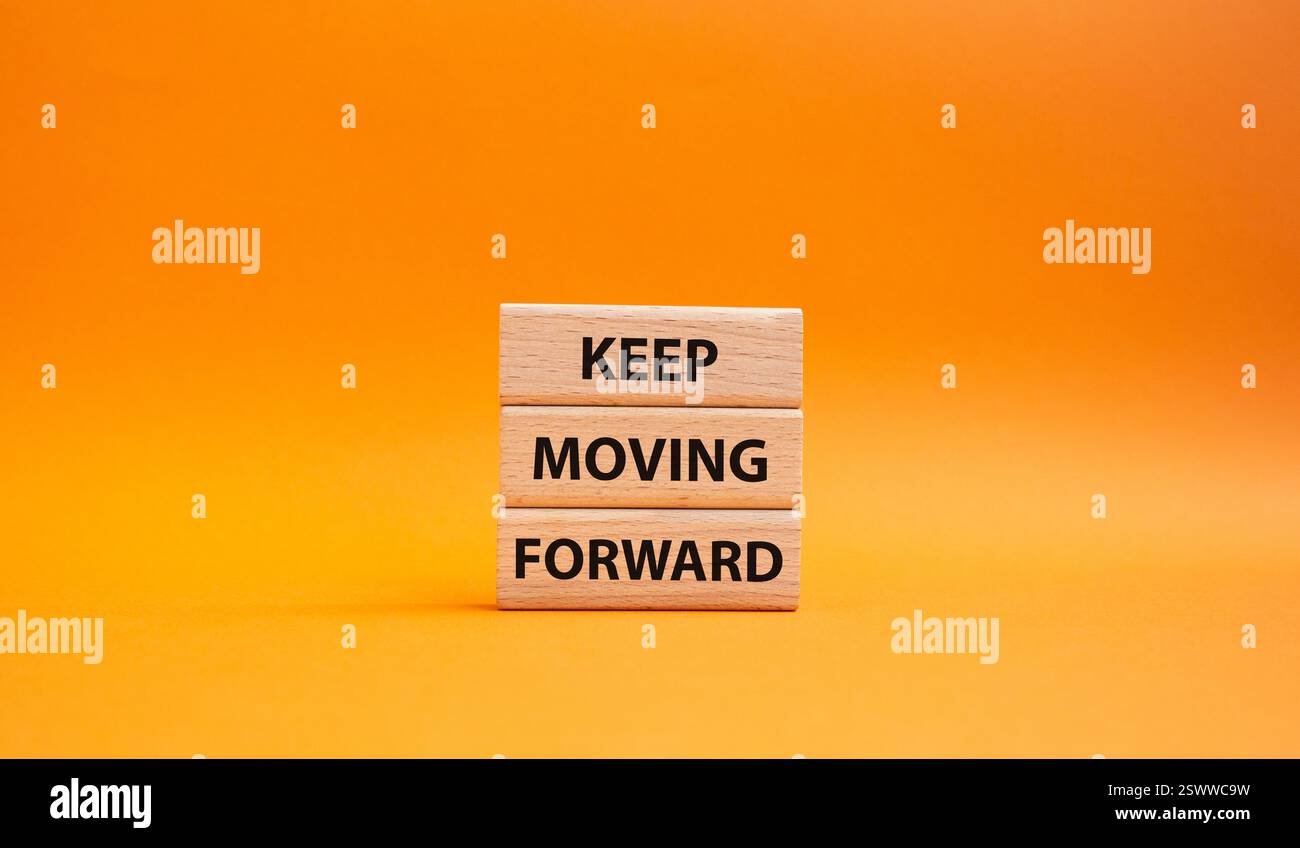 Keep moving forward symbol. Concept words keep moving forward on wooden blocks. Beautiful orange ...