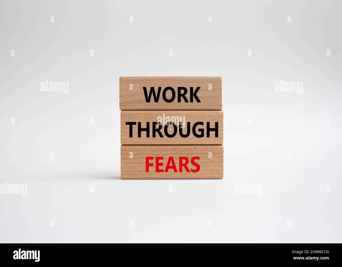 Work through fears symbol. Wooden blocks with words Work through fears ...