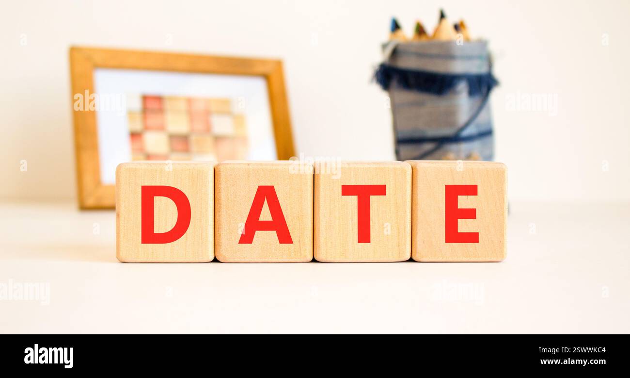 Date symbol. Concept word Date on beautiful wooden blocks. Beautiful ...