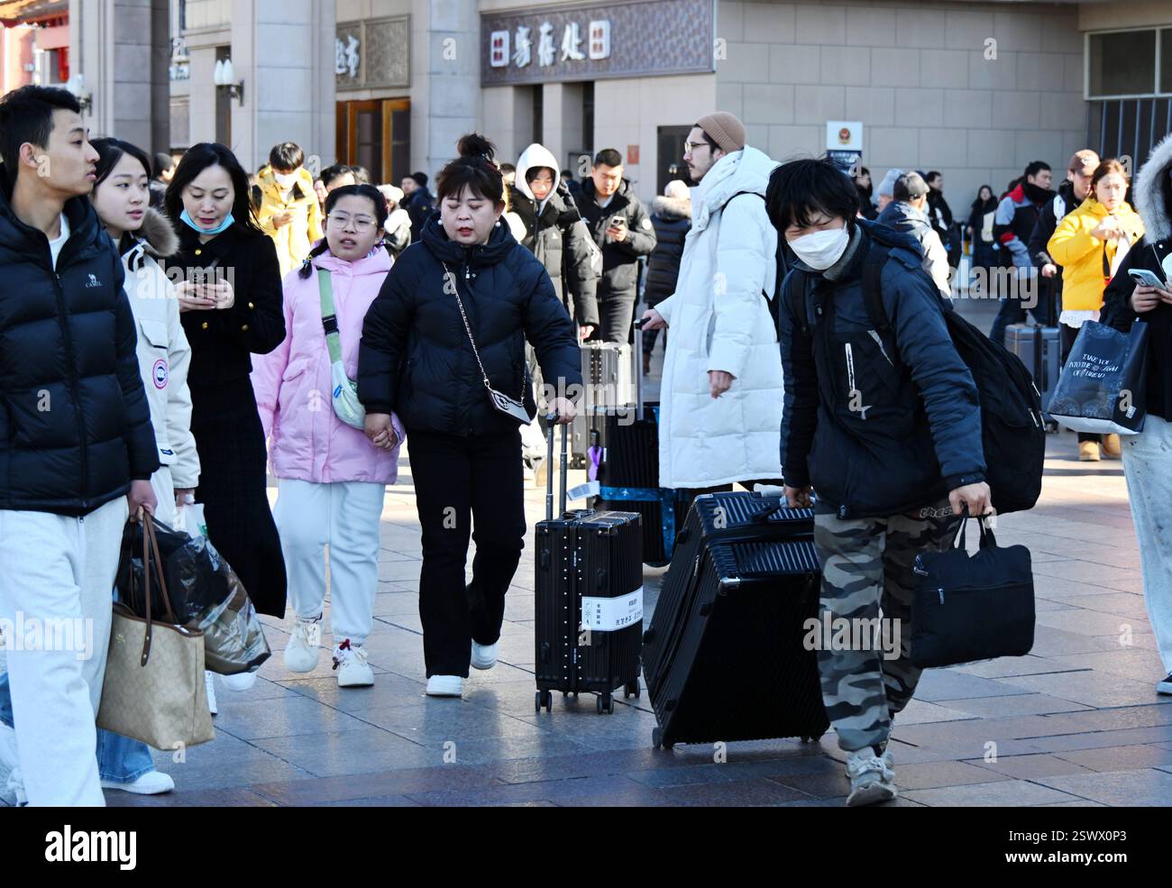 People returning to Beijing from Beijing Railway Station on February 22 ...