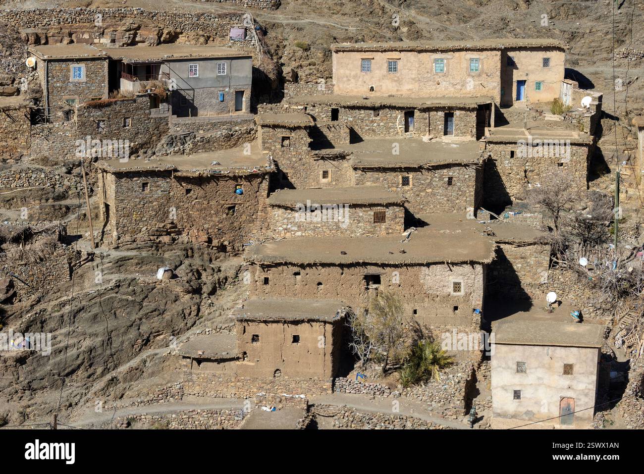 The traditional Berber village of Ait Ben Amer, with its mud houses, is ...