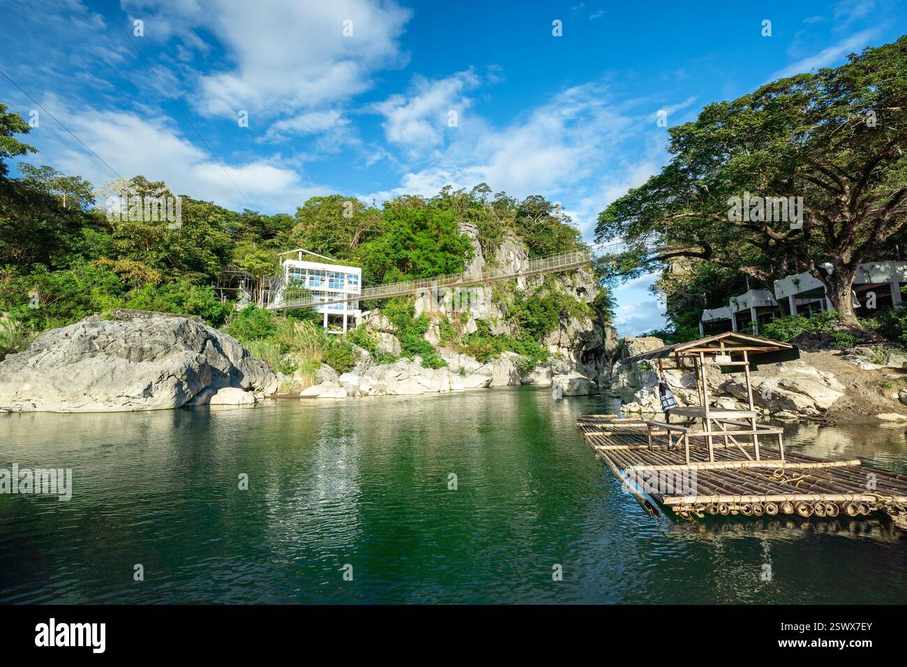 Turquoise river winding through towering limestone cliffs and lush ...