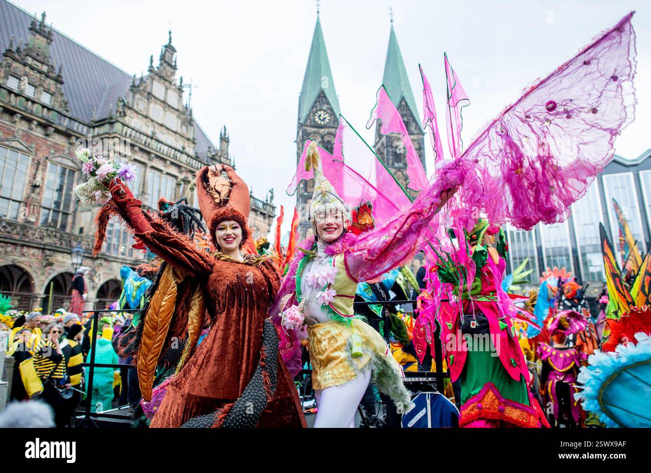 Bremen, Germany. 22nd Feb, 2025. Actors in colorful costumes stand on ...