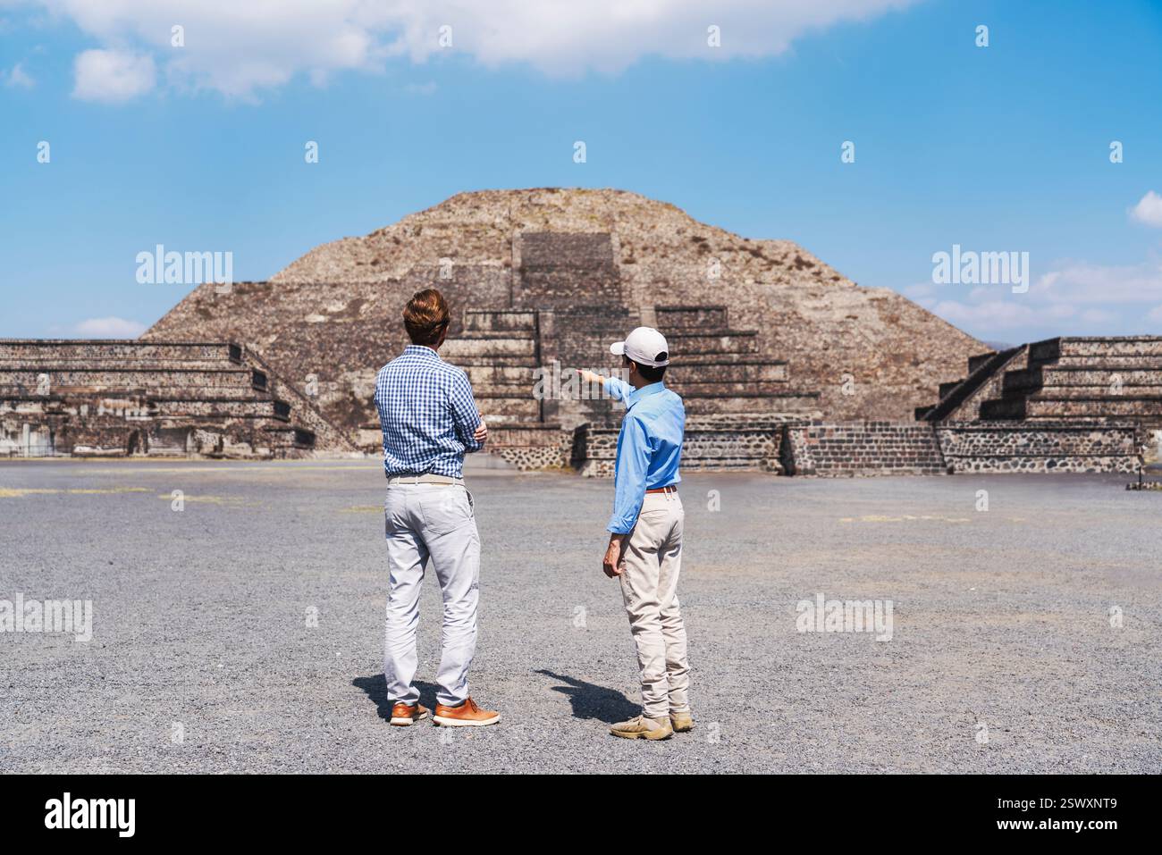 Two men stand in front of the Pyramid of the Moon in Teotihuacán ...