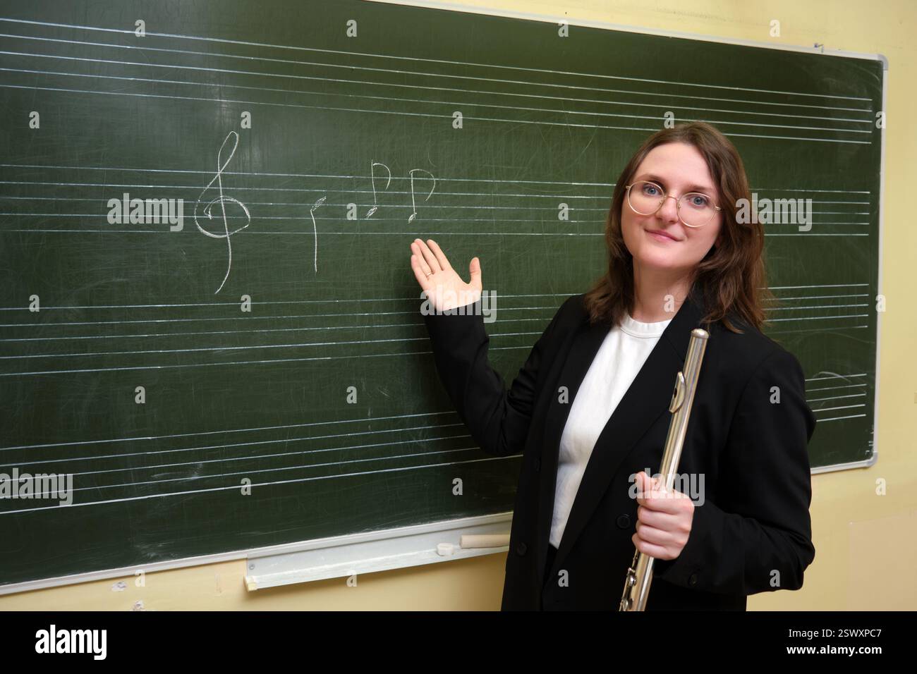The music professor is happily explaining the notes on the blackboard ...