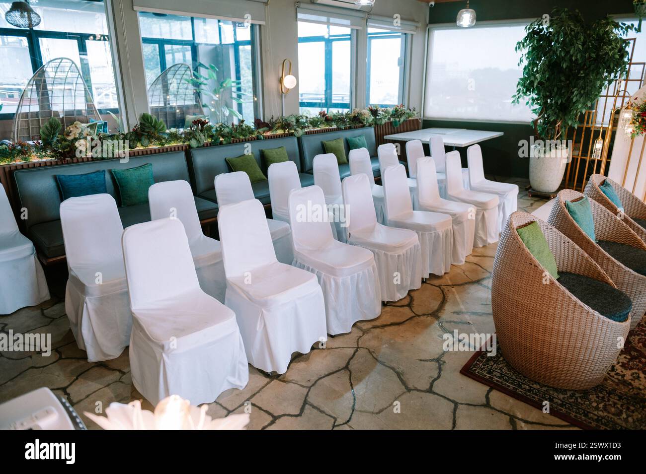 An elegant and tranquil indoor setting for a wedding ceremony. Rows of ...