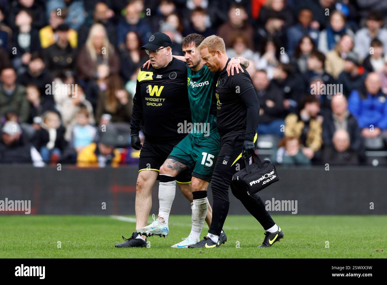 Millwall's Joe Bryan (centre) leaves the field with an injury during ...