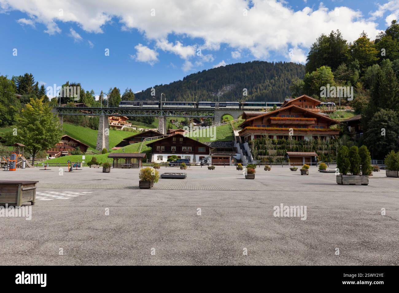 Swiss Golden pass train crosses the viaduct at Gstaad hauled by a ...