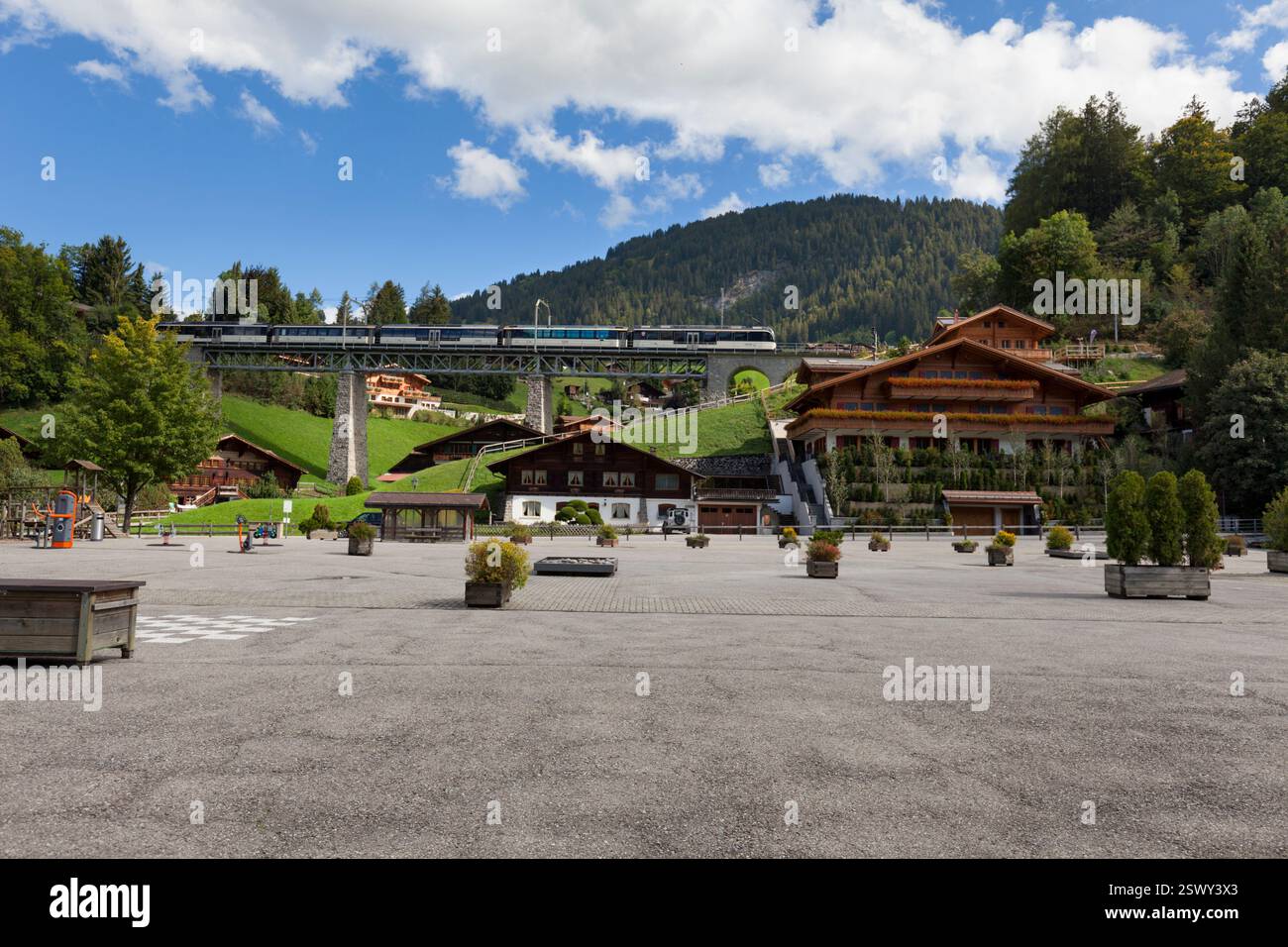 Swiss Golden pass train crosses the viaduct at Gstaad hauled by a ...