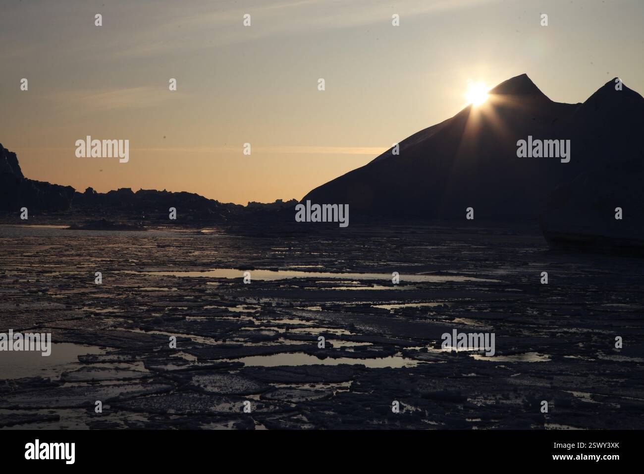 Ilulissat, Greenland. 07th Feb, 2025. The sun sets behind an iceberg in ...