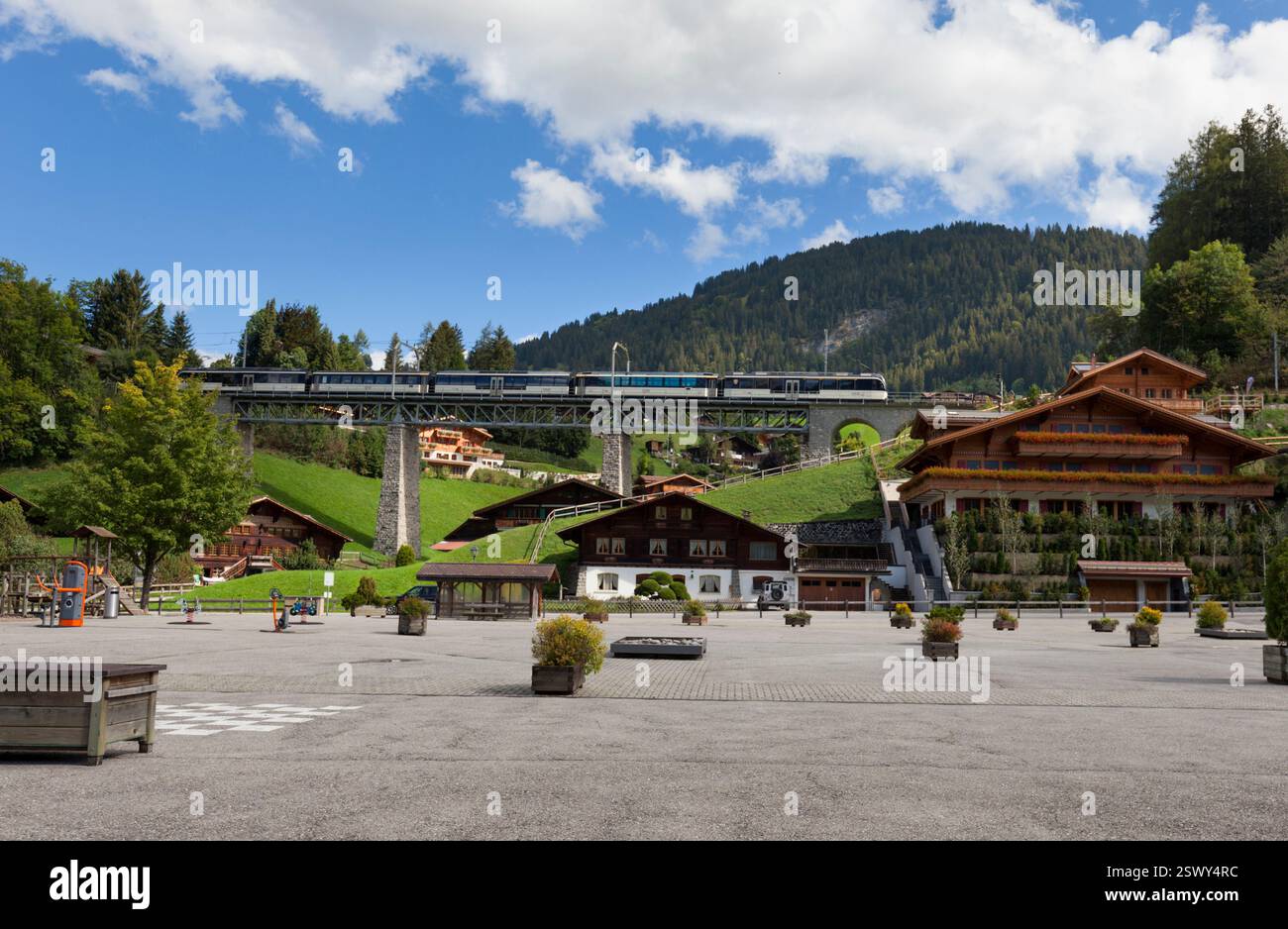 Swiss Golden pass train crosses the viaduct at Gstaad hauled by a ...
