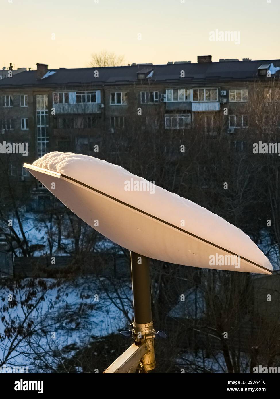 SpaceX's Starlink satellite dish is covered in snow. Starlink is ...