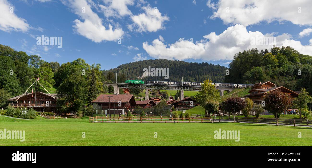 The Swiss Golden pass express train crosses the viaduct at Gstaad ...