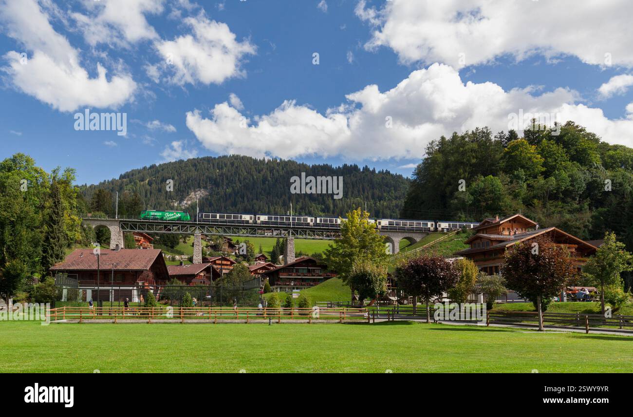 The Swiss Golden pass express train crosses the viaduct at Gstaad ...