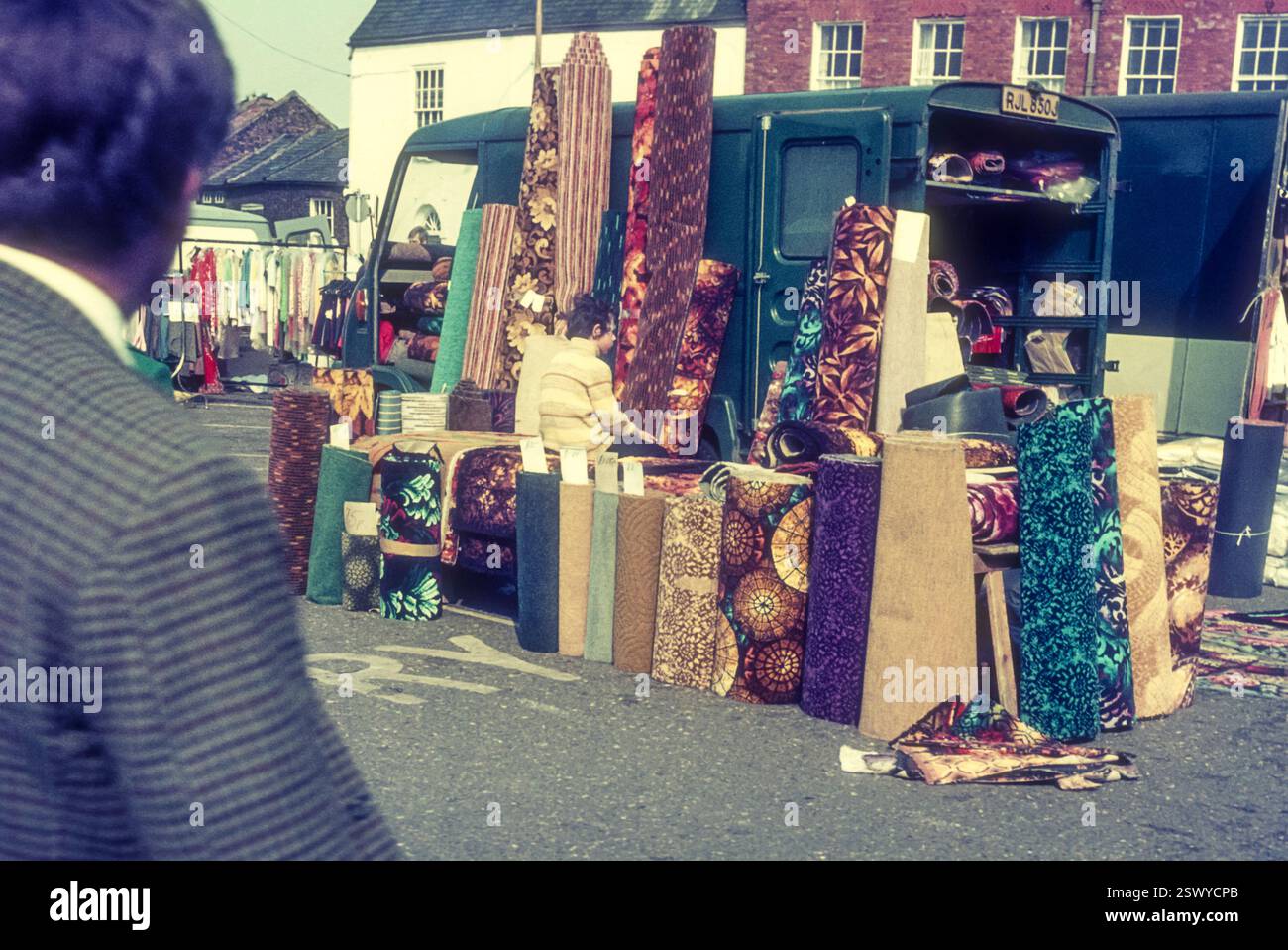 Early 1970s archive photograph of stall selling carpets on the Tuesday ...