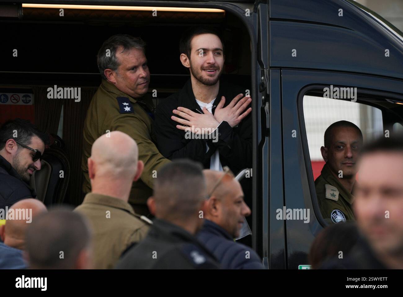 Freed Israeli hostage Omer Shem Tov gestures from a van as he arrives ...