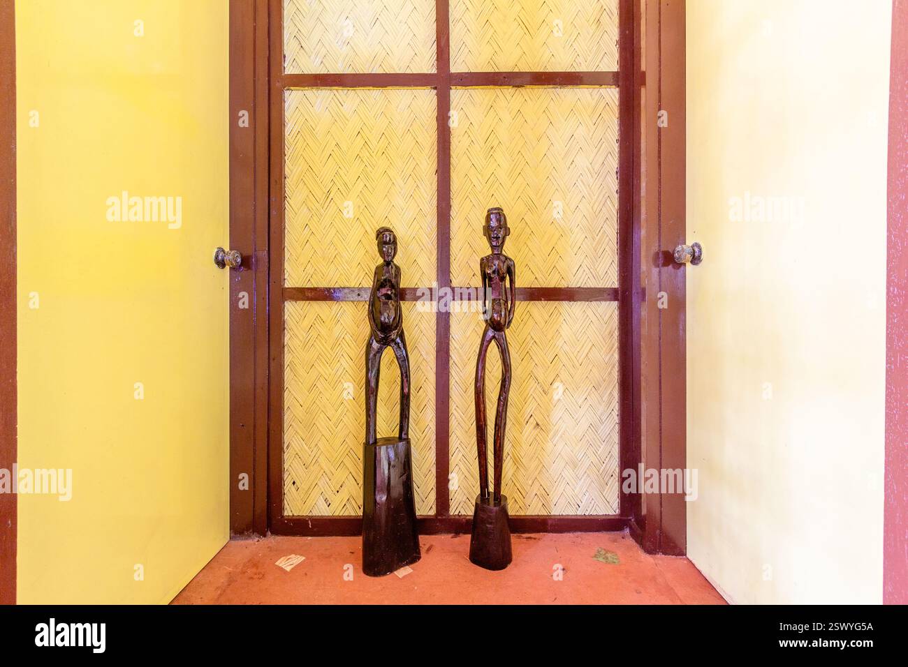 Slim wooden sculptures of indigenous figures in dark wood used as decor ...