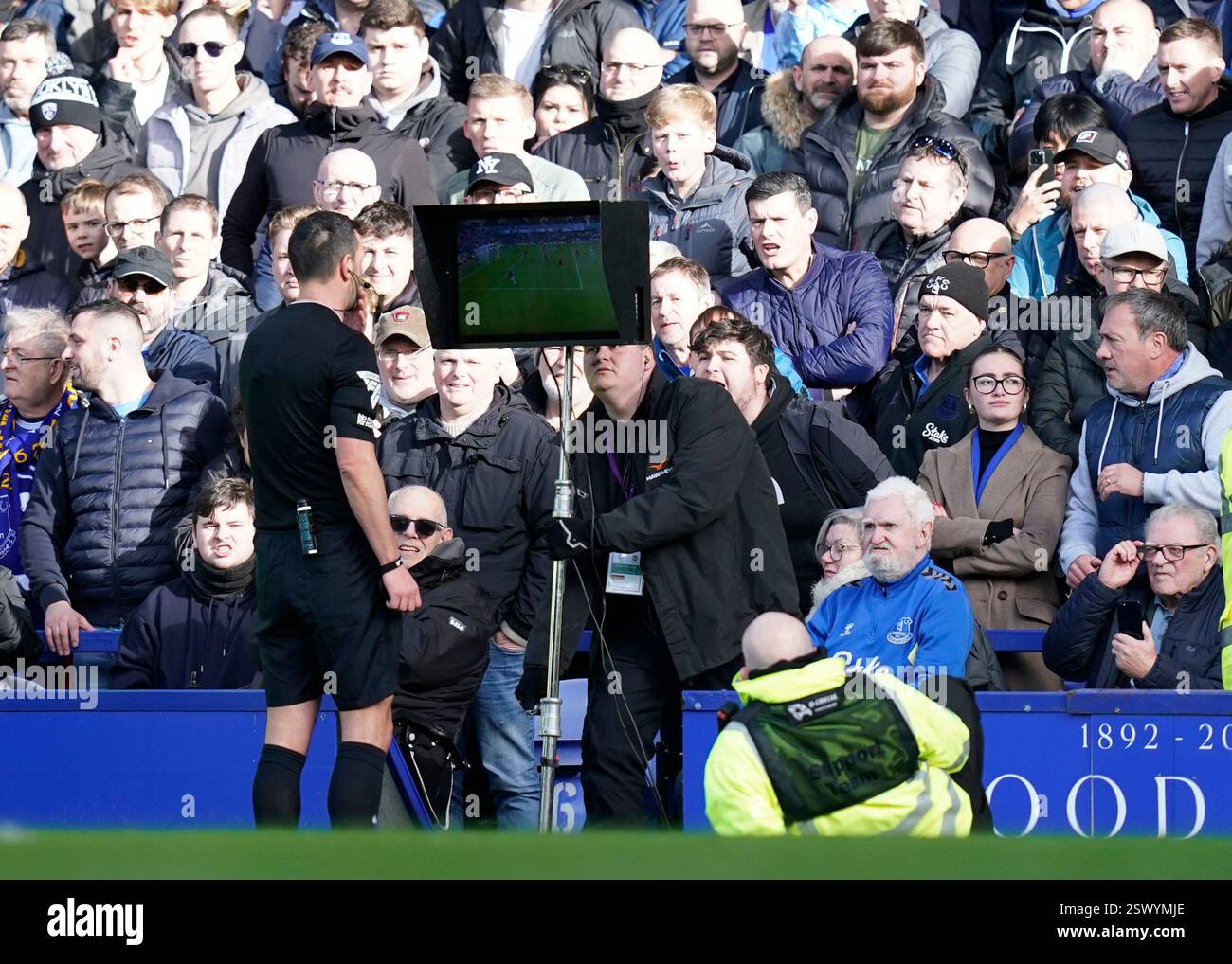Liverpool, UK. 22nd Feb, 2025. Referee Andrew Madley takes a look at ...