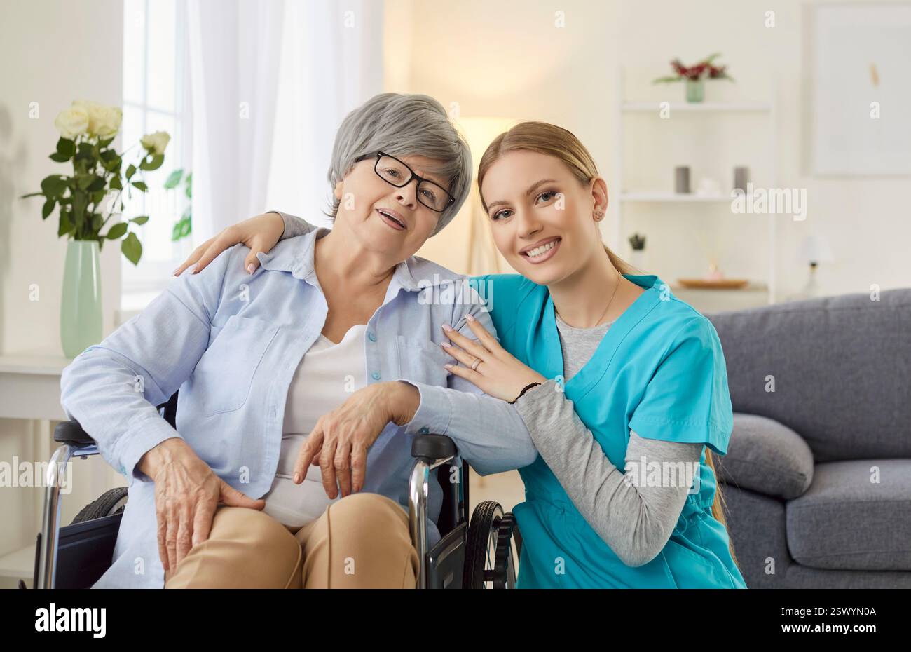 Smiling caring kind nurse and senior woman portrait, giving shoulder ...