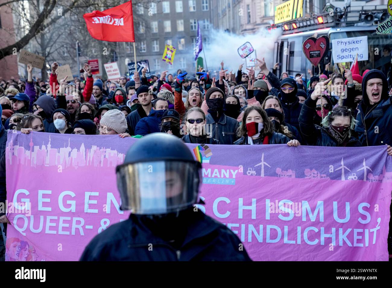 Police officers stop anti-far-right protester trying to block the route ...