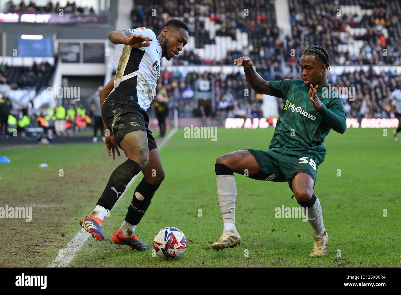 Ebou Adams of Derby County under pressure from Zak Sturge of Millwall ...