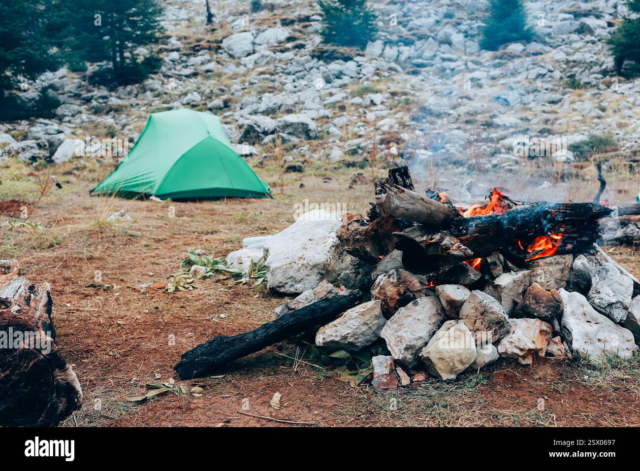 campfire close-up , out of focus tourist tent on the background ...