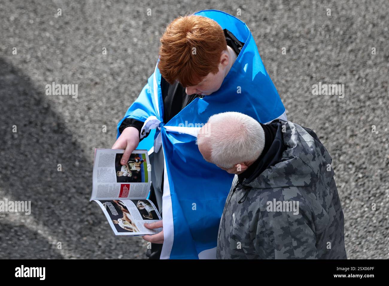 A Scotland fans reading the match day program during the 2025 Guinness ...