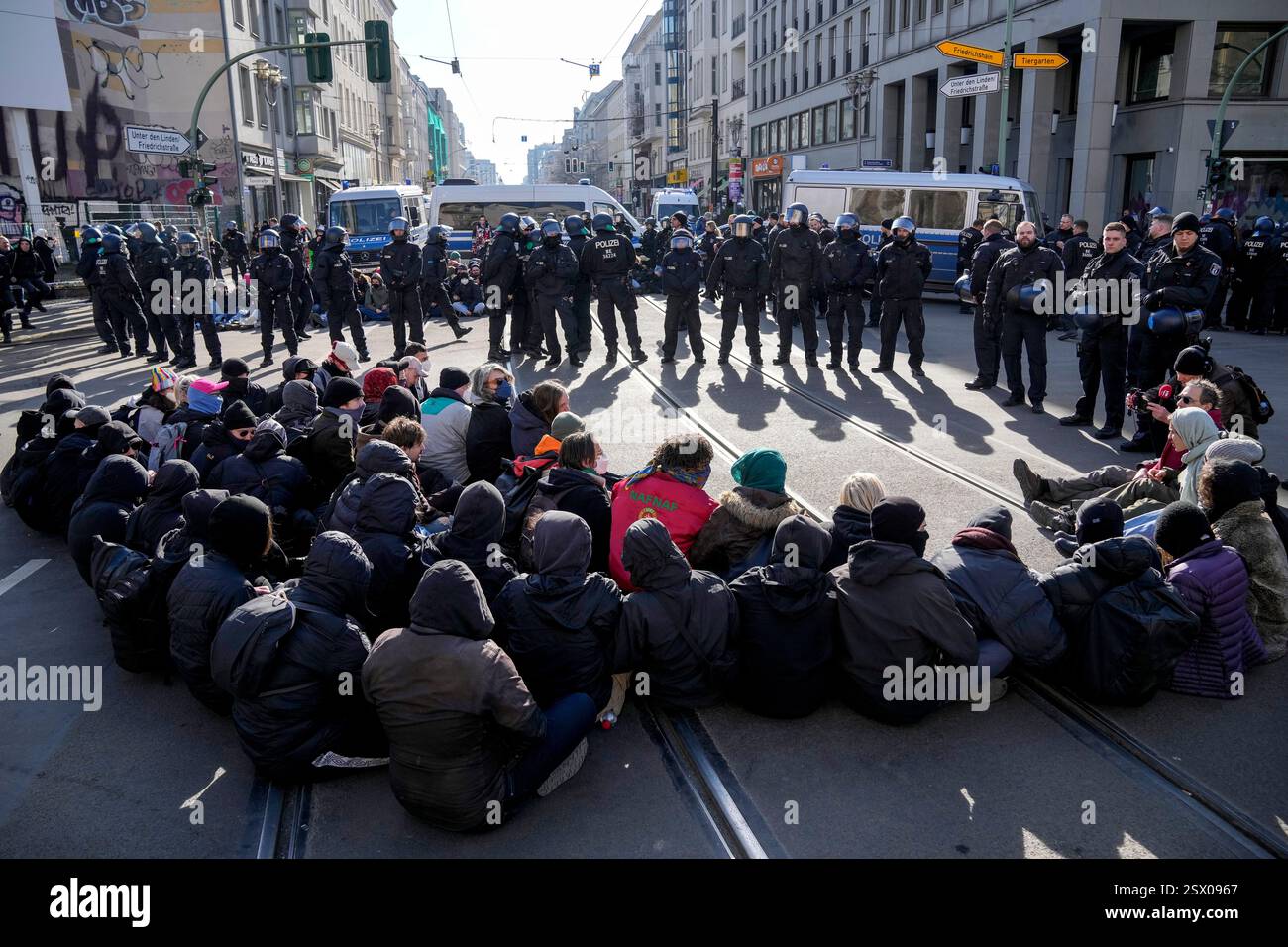 Police officers stop anti-far-right protester trying to block the route ...