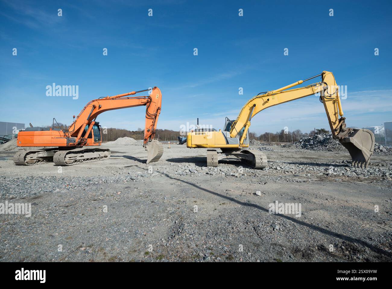 Two excavators on a building site Stock Photo - Alamy