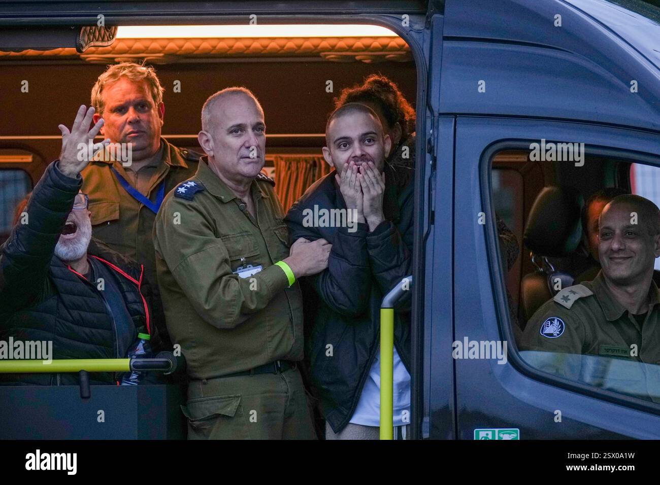 Freed Israeli hostage Omer Wenkert, gestures from a van as he arrives ...