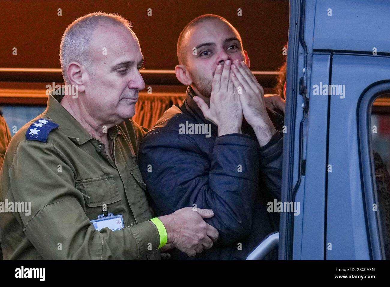 Freed Israeli hostage Omer Wenkert, gestures from a van as he arrives ...