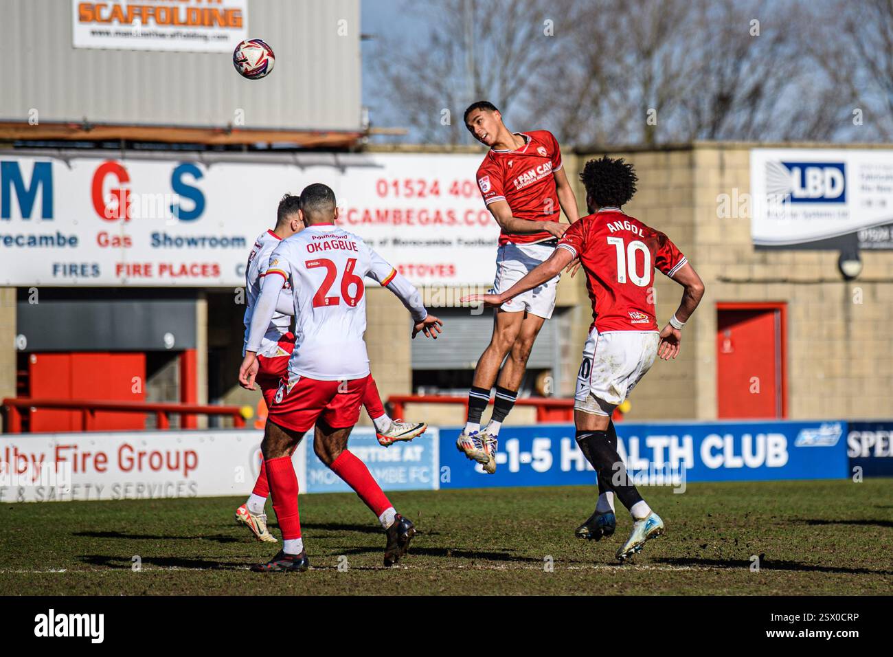 Morecambe FC's Marcus Dackers tries a head shot towards goal during the ...