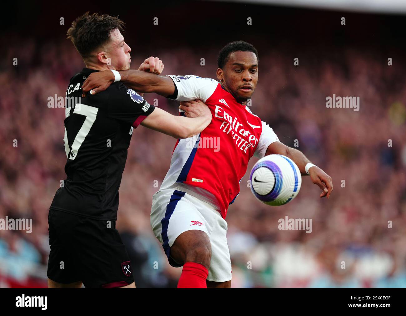 West Ham United's Oliver Scarles (left) and Arsenal's Jurrien Timber ...