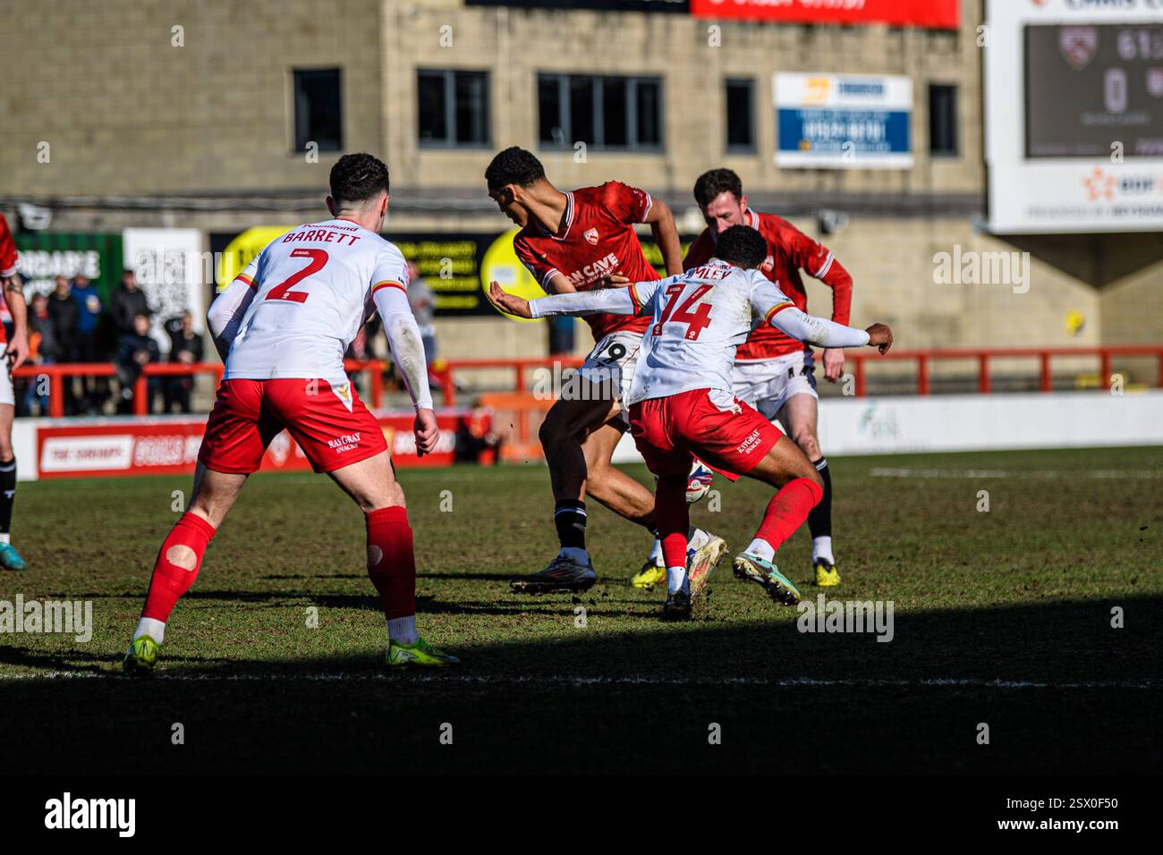 Morecambe FC's Marcus Dackers is tackled by Brandon Comley of Walsall ...